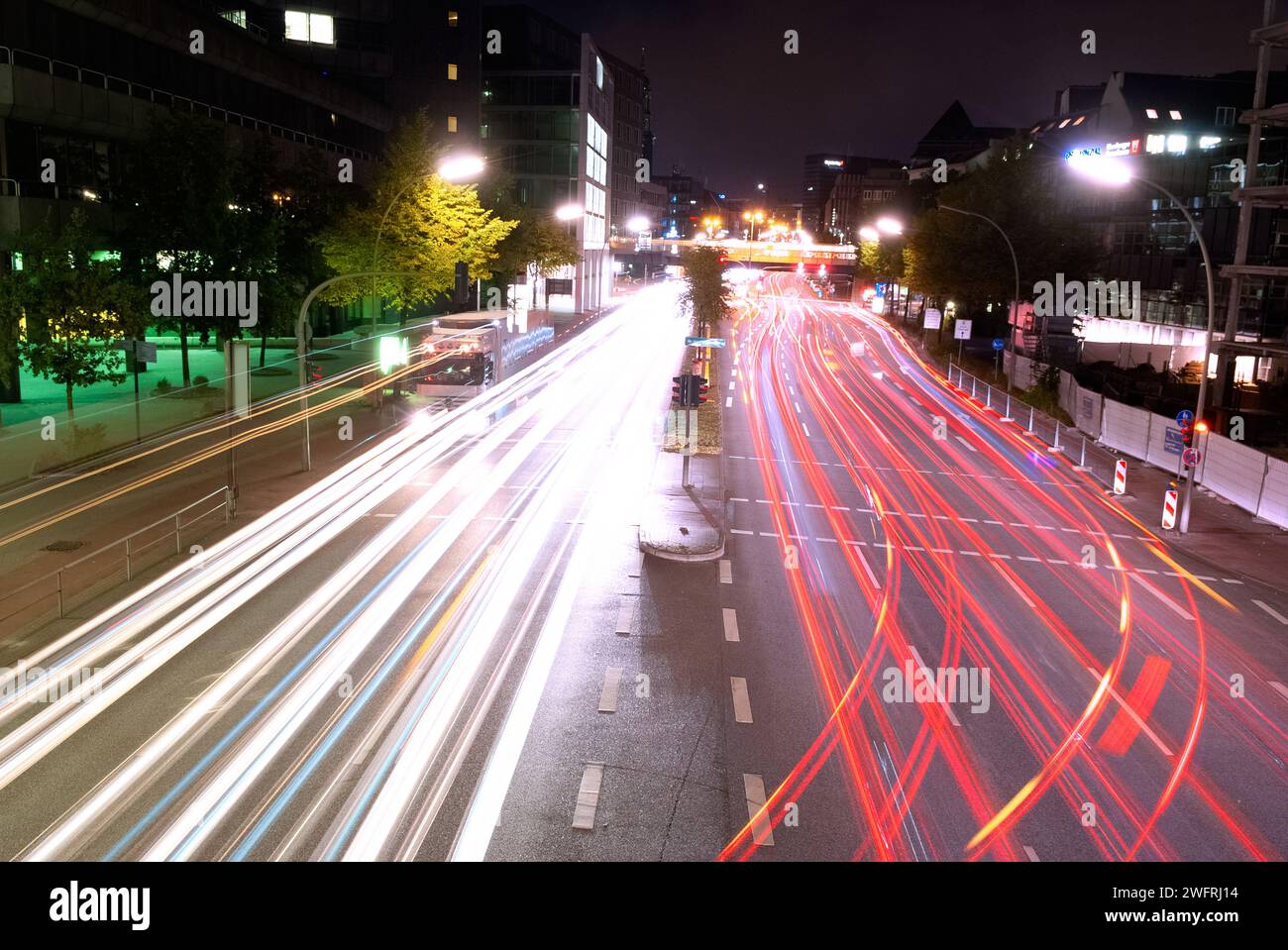 Long exposure shot of traffic light trails on city streets at night ...
