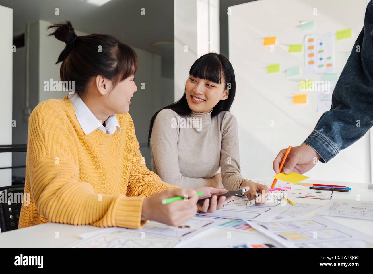 team of UI UX web designer are working together to develop mobile ...