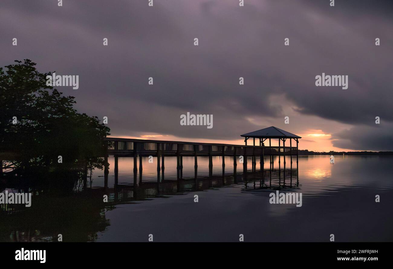 Gloomy morning sunrise dock Stock Photo - Alamy