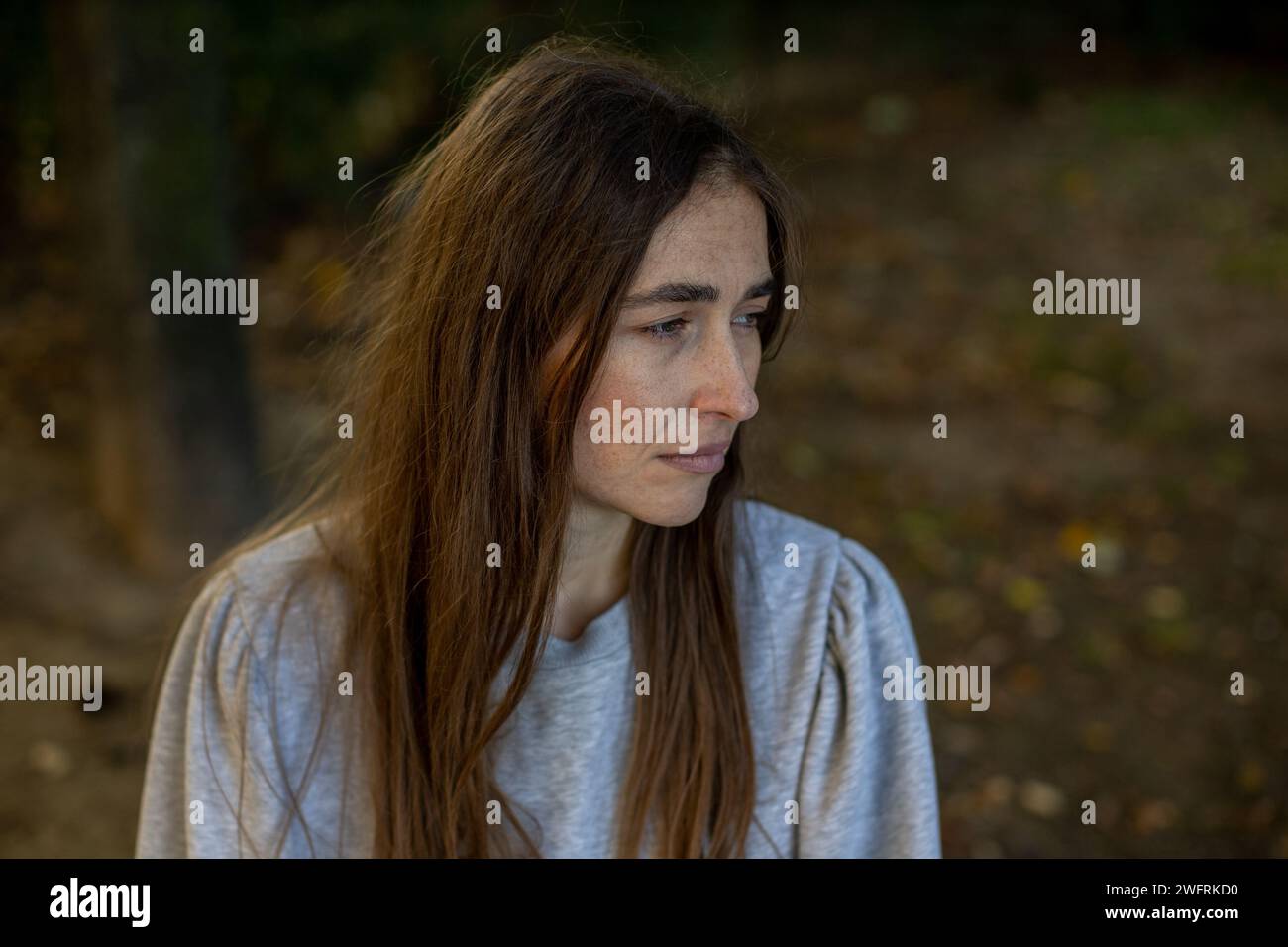 sad woman looking at her side Stock Photo - Alamy