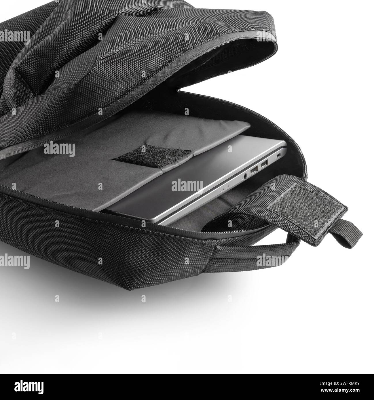 Black backpack with a laptop inside the open main compartment. Rucksack ...