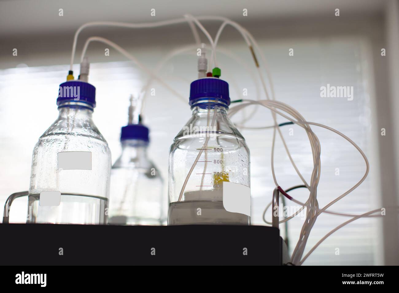 laboratory glass bottles with plastic cables Stock Photo - Alamy