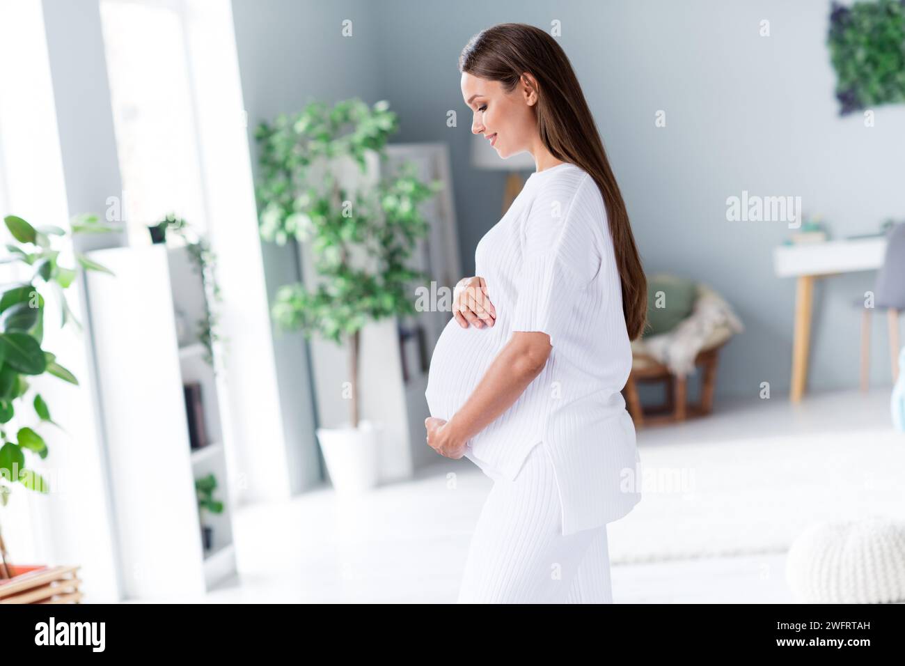 Profile side photo of lovely cheerful positive pregnant girl mama hands ...