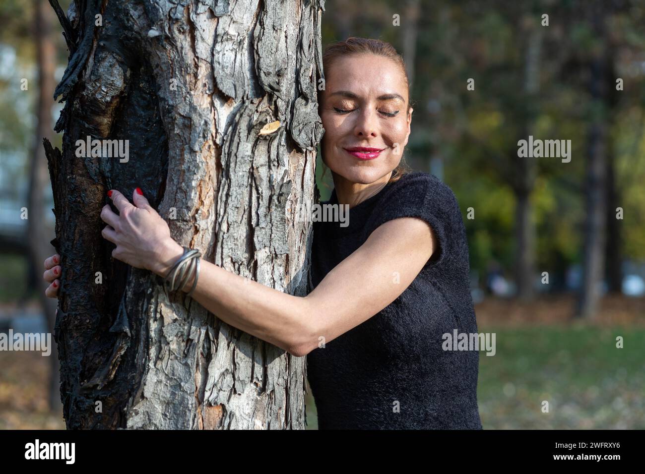 Tree hugging young woman arms hi-res stock photography and images - Alamy