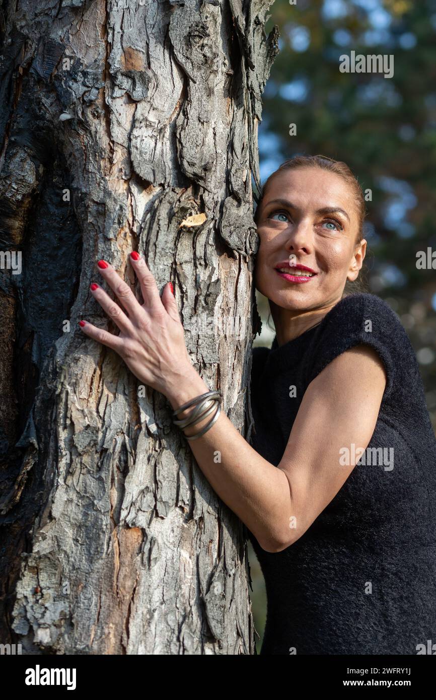 Tree hugging young woman arms hi-res stock photography and images - Alamy