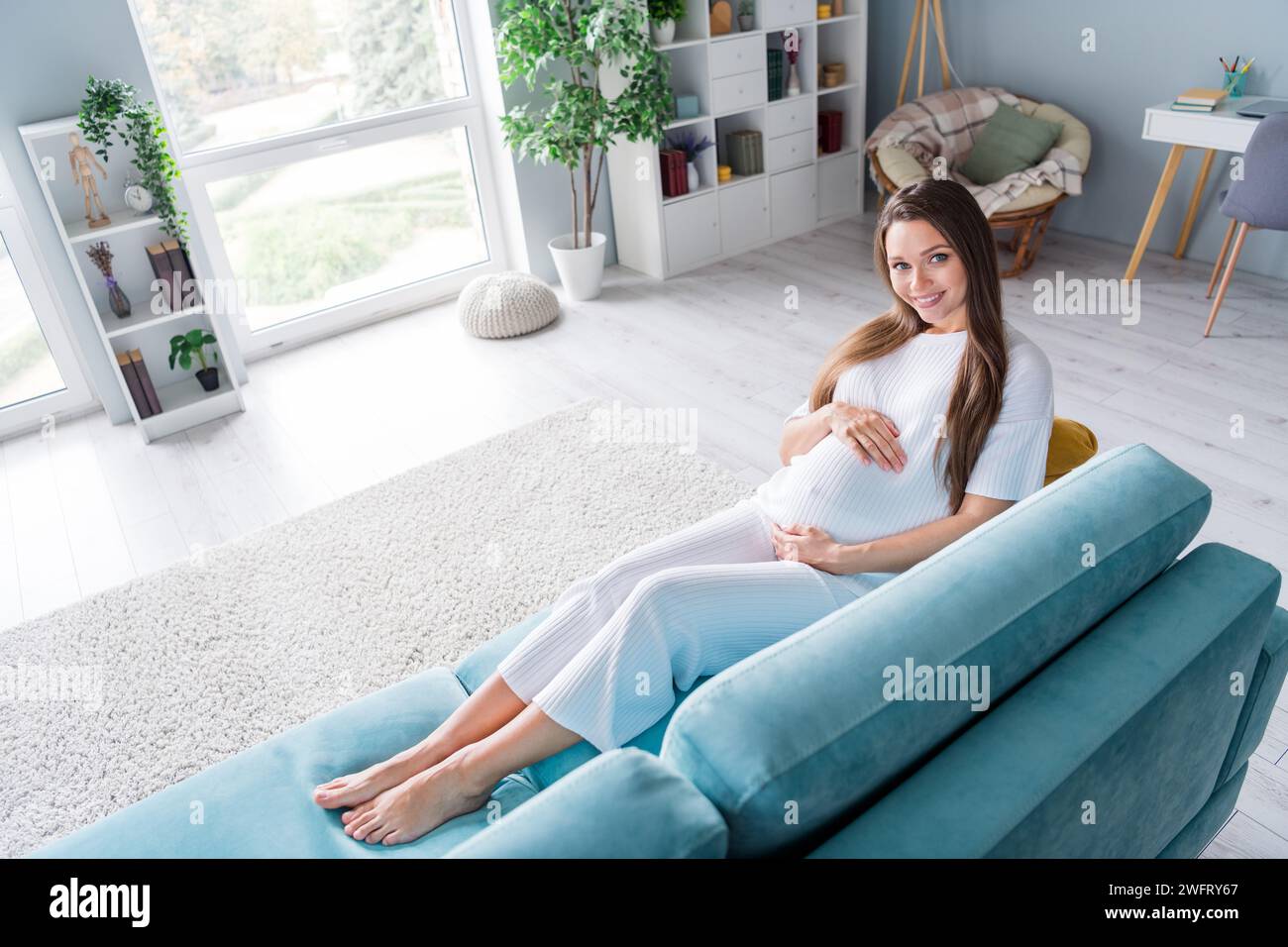 Photo of lovely pretty cute girl lying on soft divan enjoying pregnancy ...