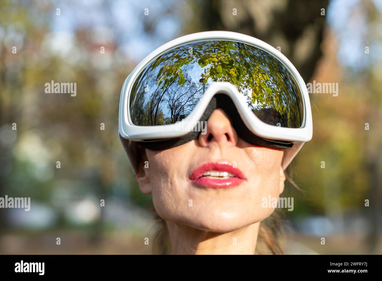 woman wearing goggles with autumn leaves being reflected Stock Photo ...