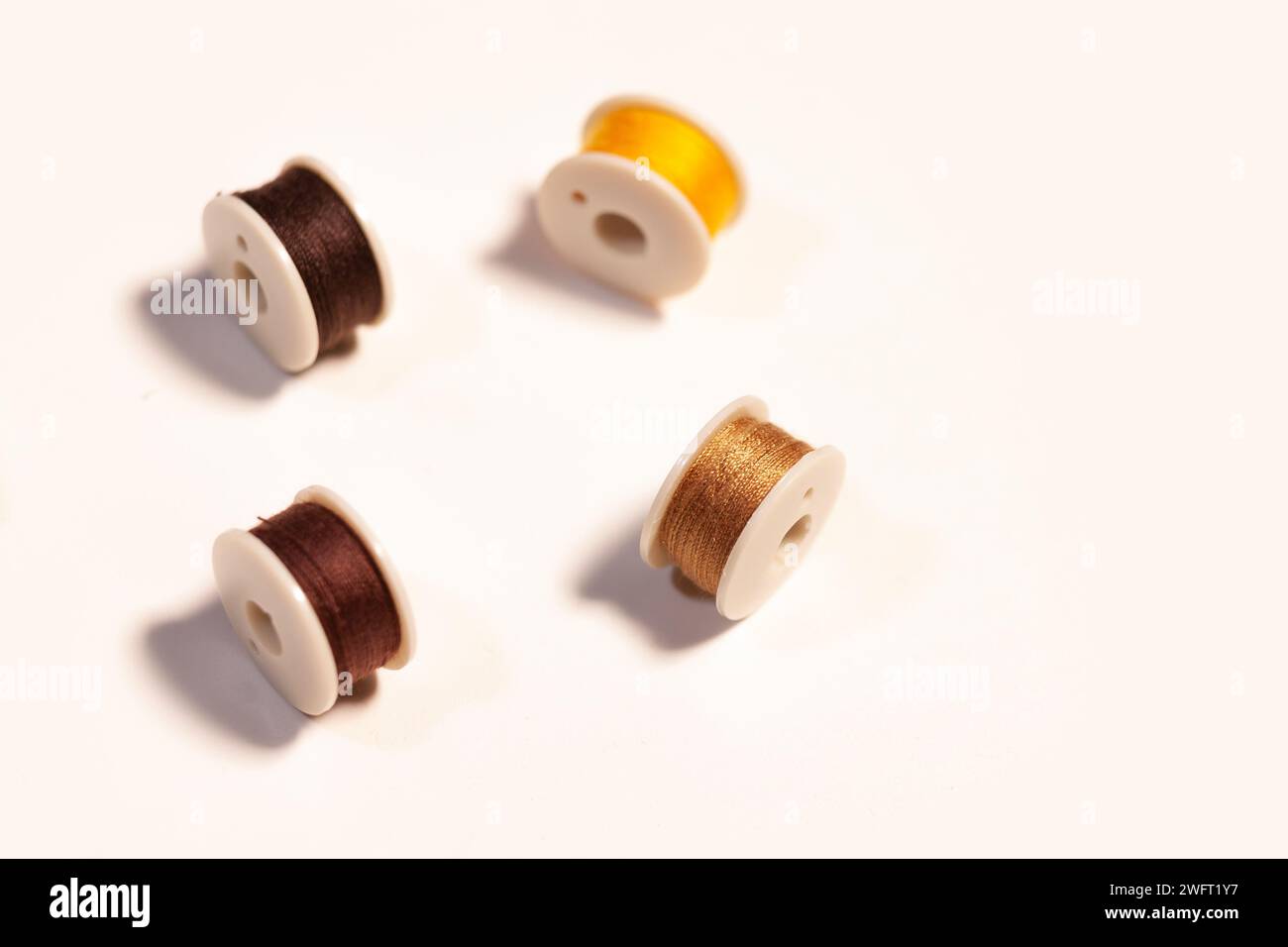 colorful sewing threads on bobbins isolated on white Stock Photo - Alamy