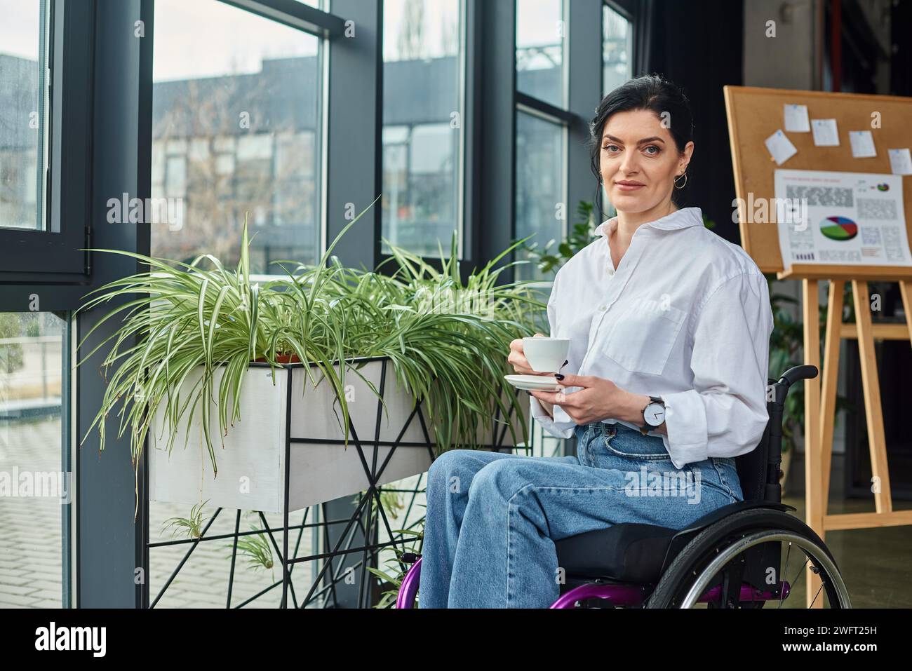 jolly beautiful disabled woman in business attire in wheelchair holding ...