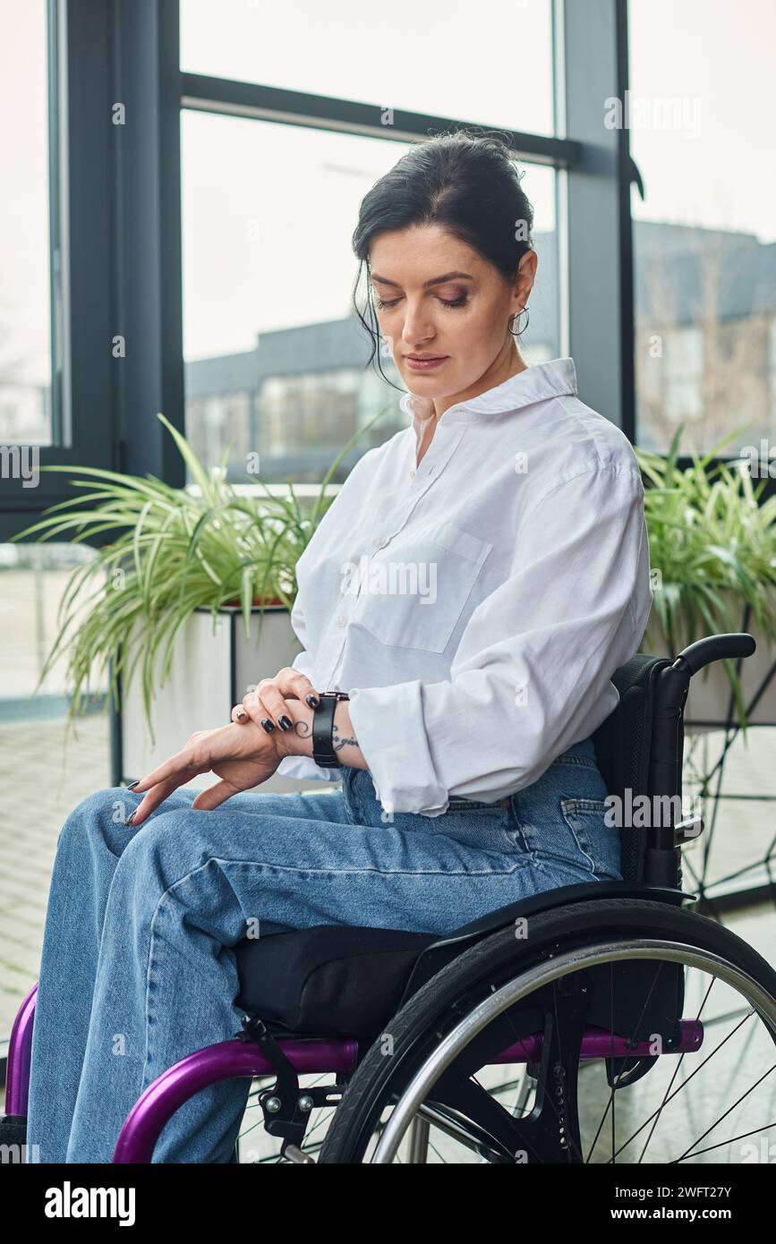 good looking disabled woman in chic attire sitting in wheelchair and ...