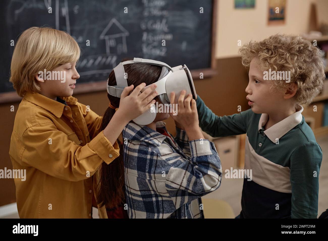Side view portrait of schoolgirl putting on VR headset for immersive ...