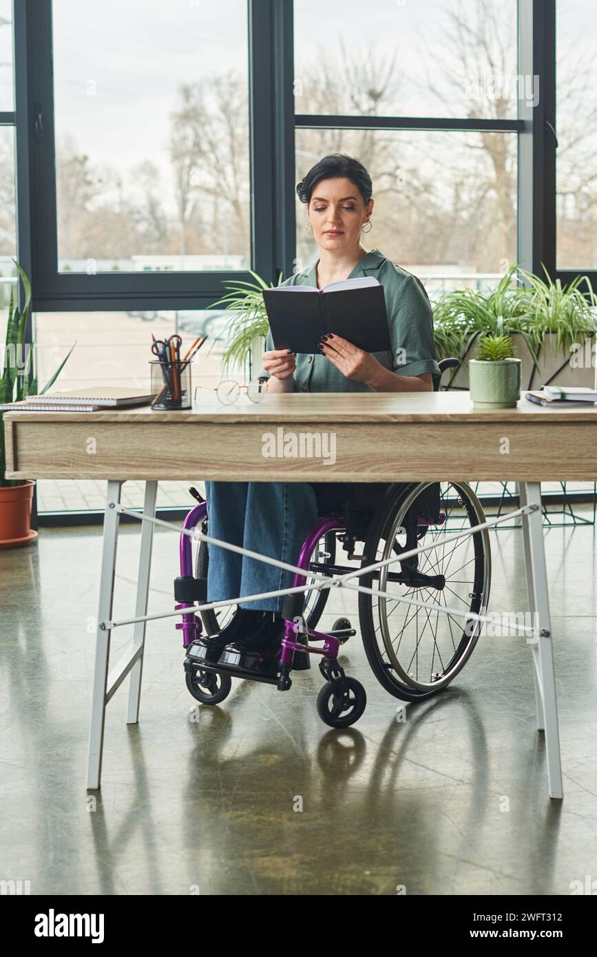 good looking confident disabled businesswoman in wheelchair looking at ...