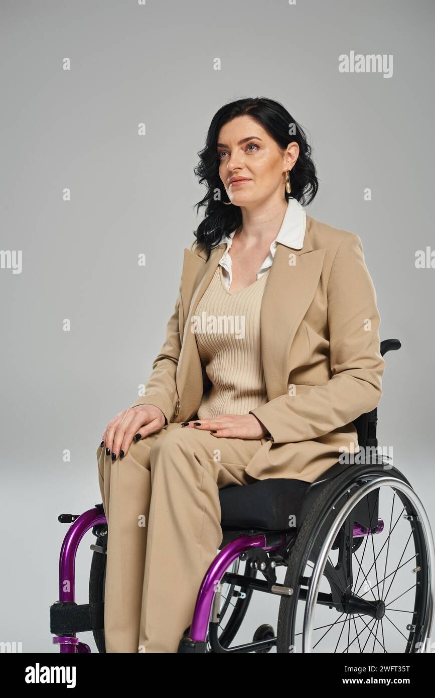 confident brunette woman with disability in pastel outfit sitting in ...