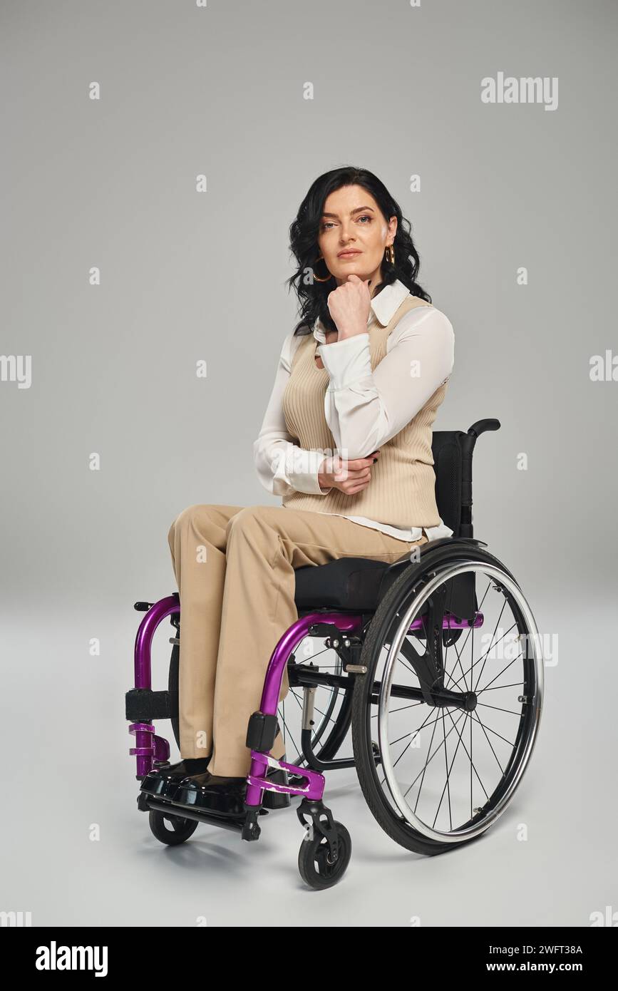 beautiful confident disabled woman in pastel clothes sitting in ...