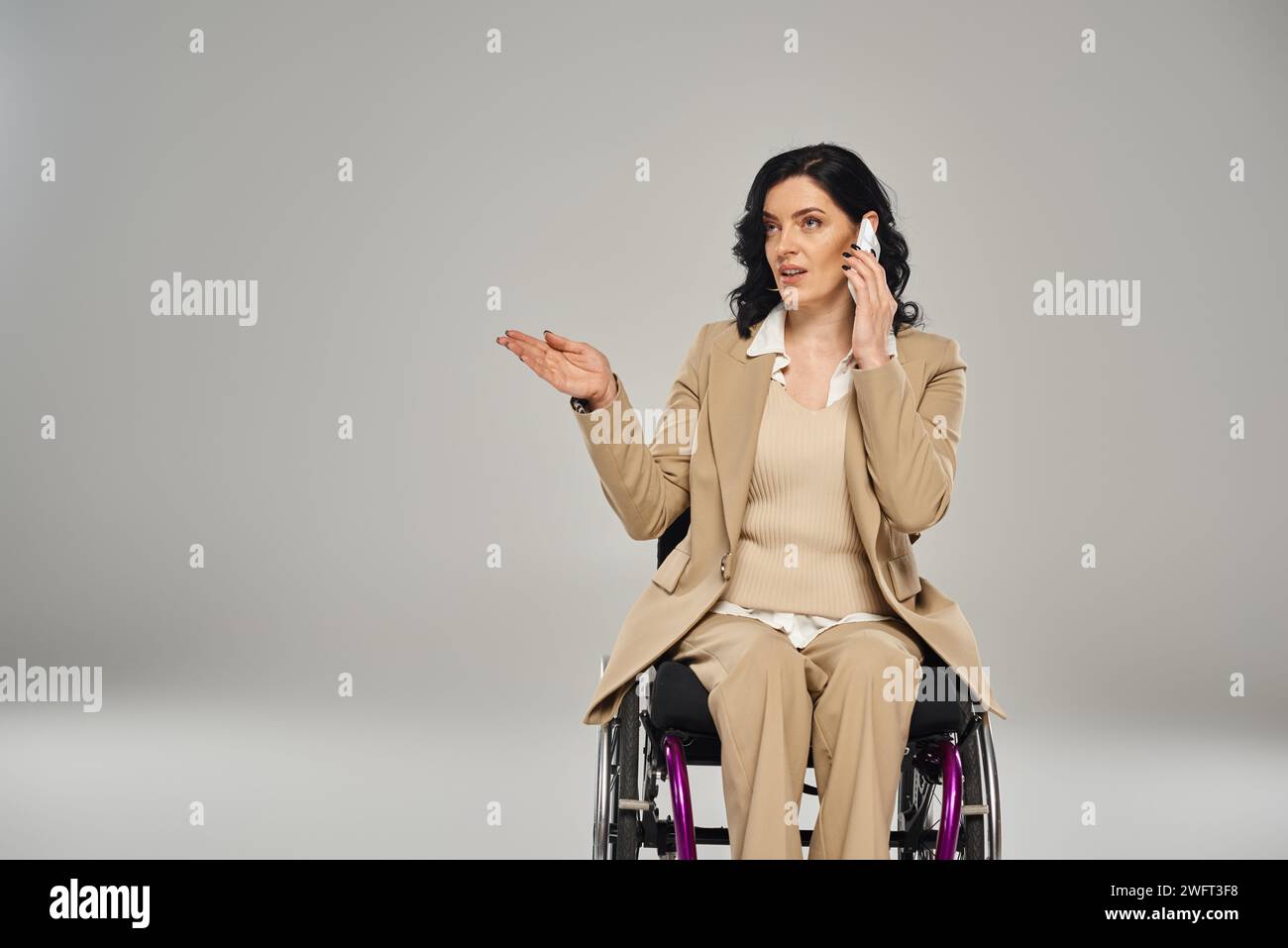 confident good looking disabled woman in pastel suit in wheelchair ...