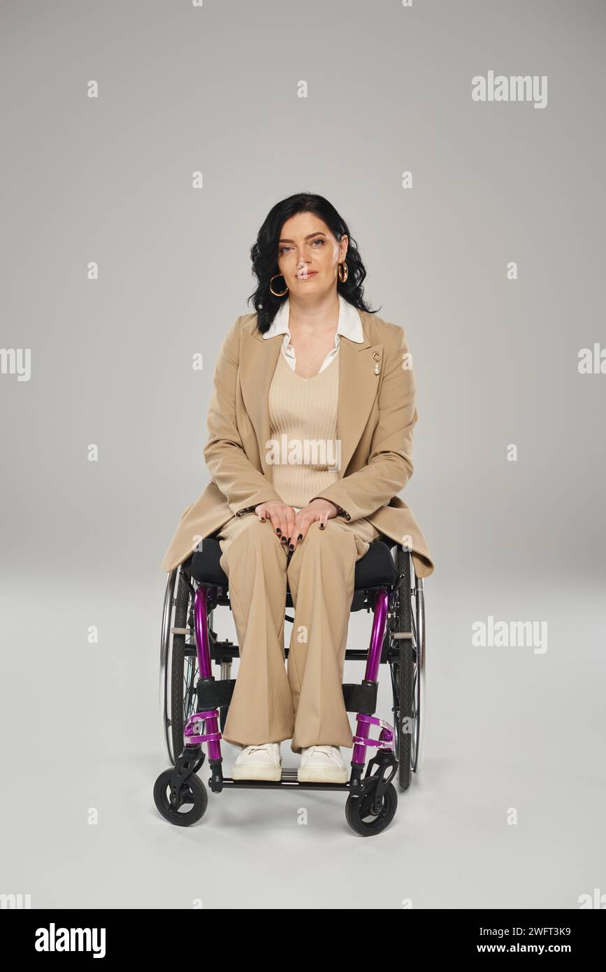 good looking disabled woman in elegant pastel suit in wheelchair ...