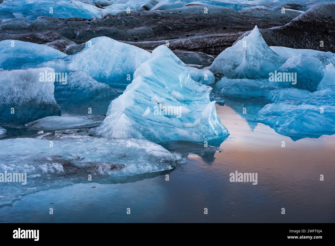 Icebergs beautifully mirrored in a serene body of water Stock Photo - Alamy