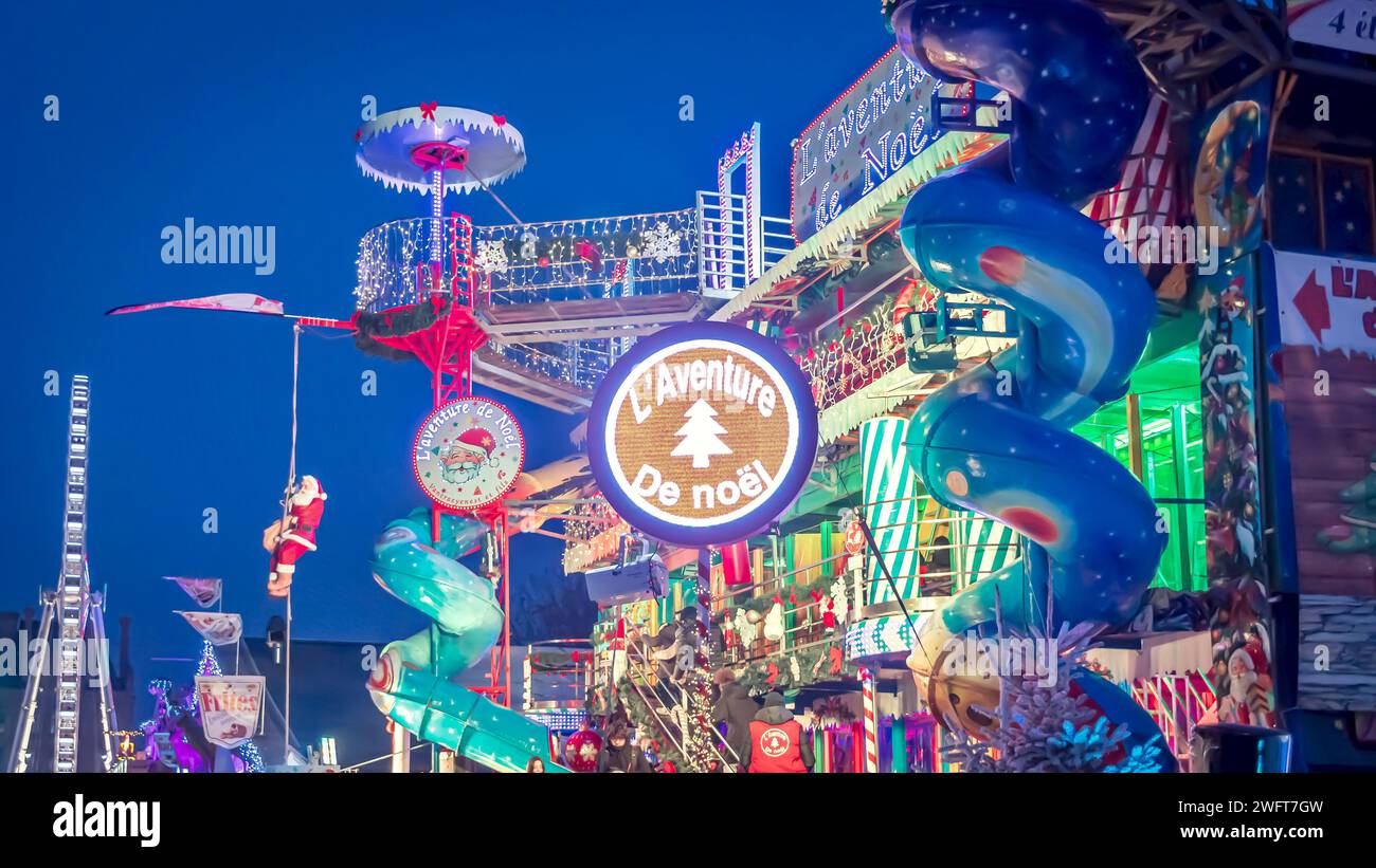 A busy city street at night with vibrant lighting and festive ...