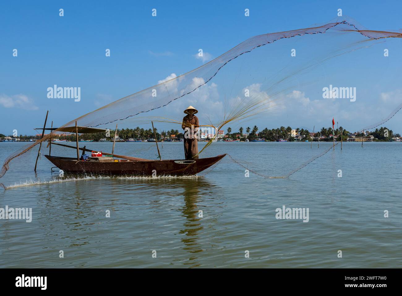 An old fisherman is throwing a net to catch fish Stock Photo - Alamy