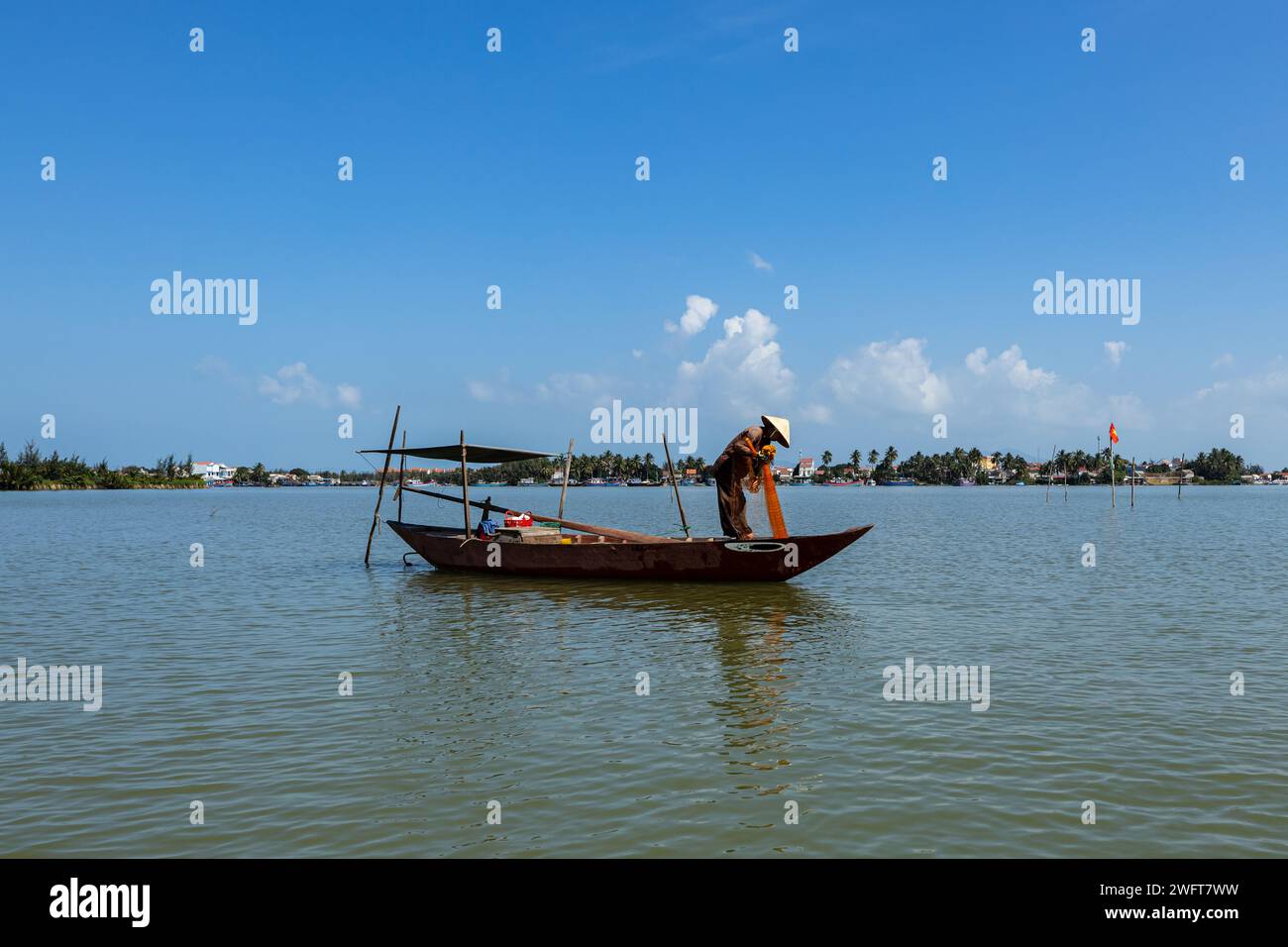 An old fisherman is throwing a net to catch fish Stock Photo - Alamy