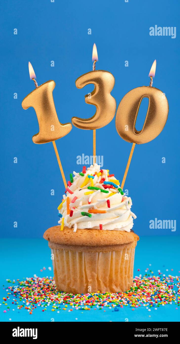 Birthday cupcake with candle number 130 - Blue background Stock Photo ...