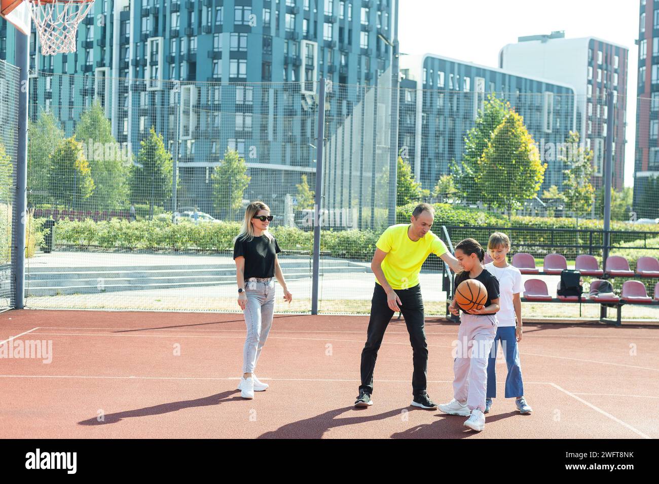 family playing basketball on court Stock Photo - Alamy
