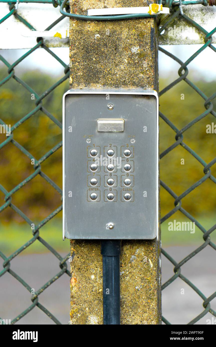 metal security entry key pad mounted on concrete post and fence Stock ...