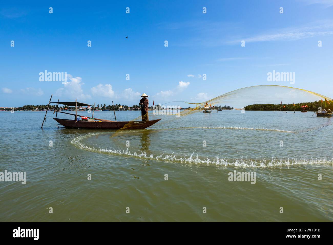 An old fisherman is throwing a net to catch fish Stock Photo - Alamy