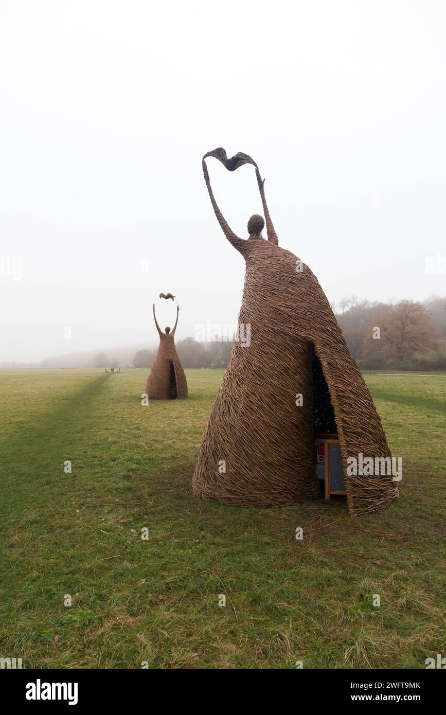 Sculpture of woman releasing bird (a peace dove perhaps), made from willow tree branches, by ...