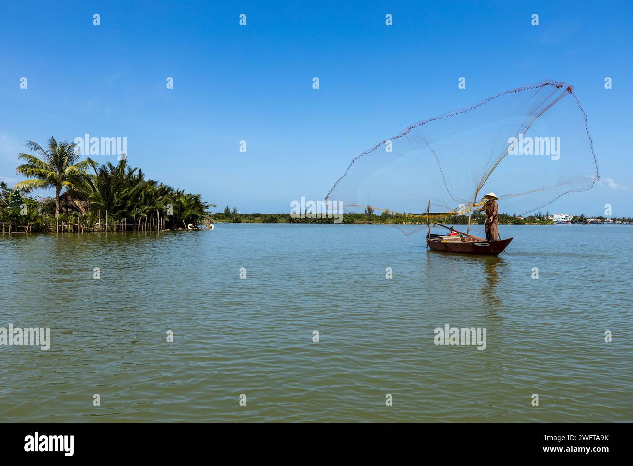 An old fisherman is throwing a net to catch fish Stock Photo - Alamy