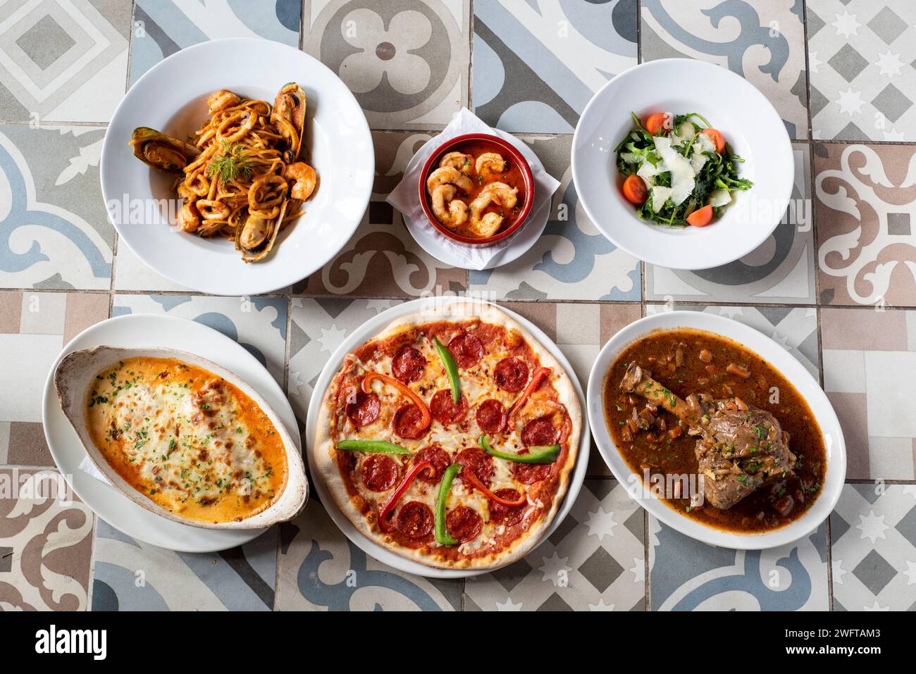 Doncaster, UK - 2019 Mar 15: Selected dishes: lamb shank, pizza diavolo ...