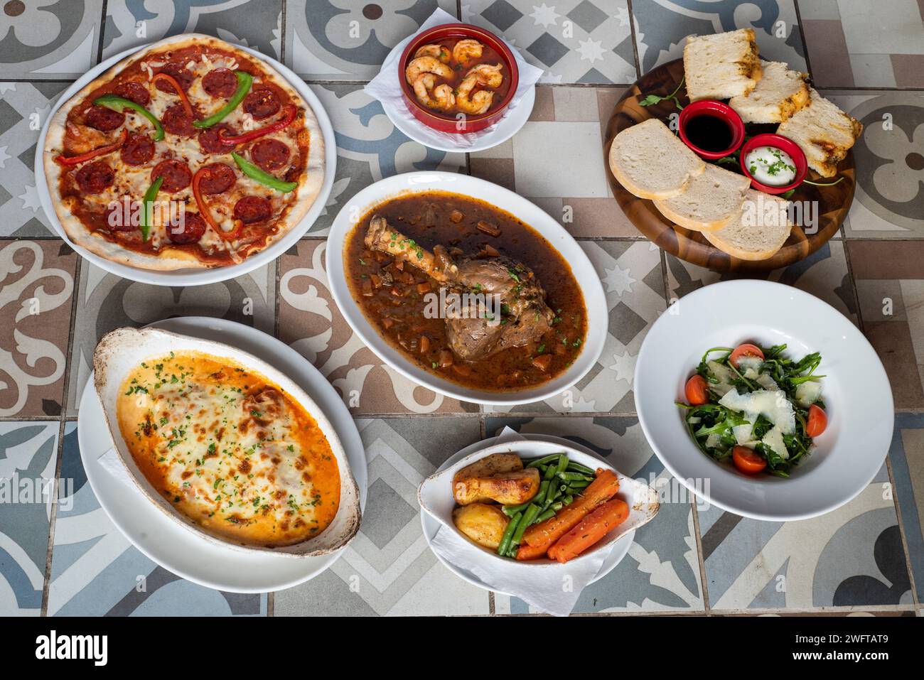 Doncaster, UK - 2019 Mar 15: Selected dishes: lamb shank, pizza diavolo ...