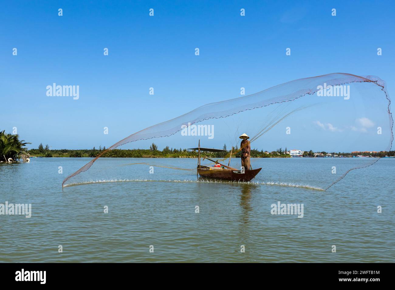 An old fisherman is throwing a net to catch fish Stock Photo - Alamy