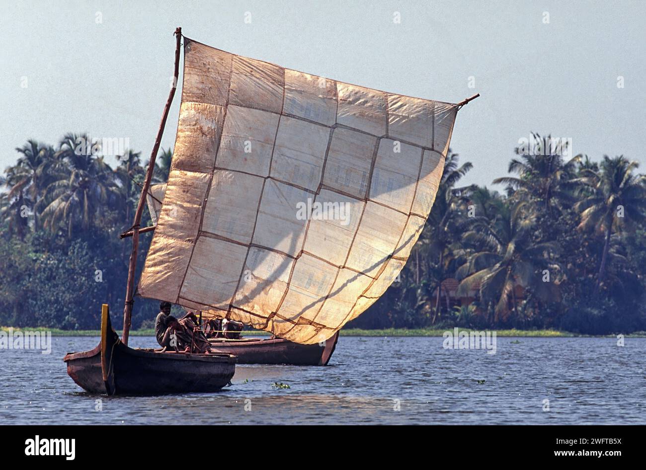 Rural India Kerala boat sailing on a backwater canal with sail made ...