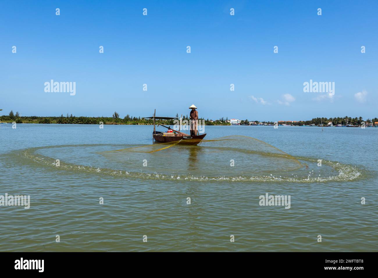 An old fisherman is throwing a net to catch fish Stock Photo - Alamy
