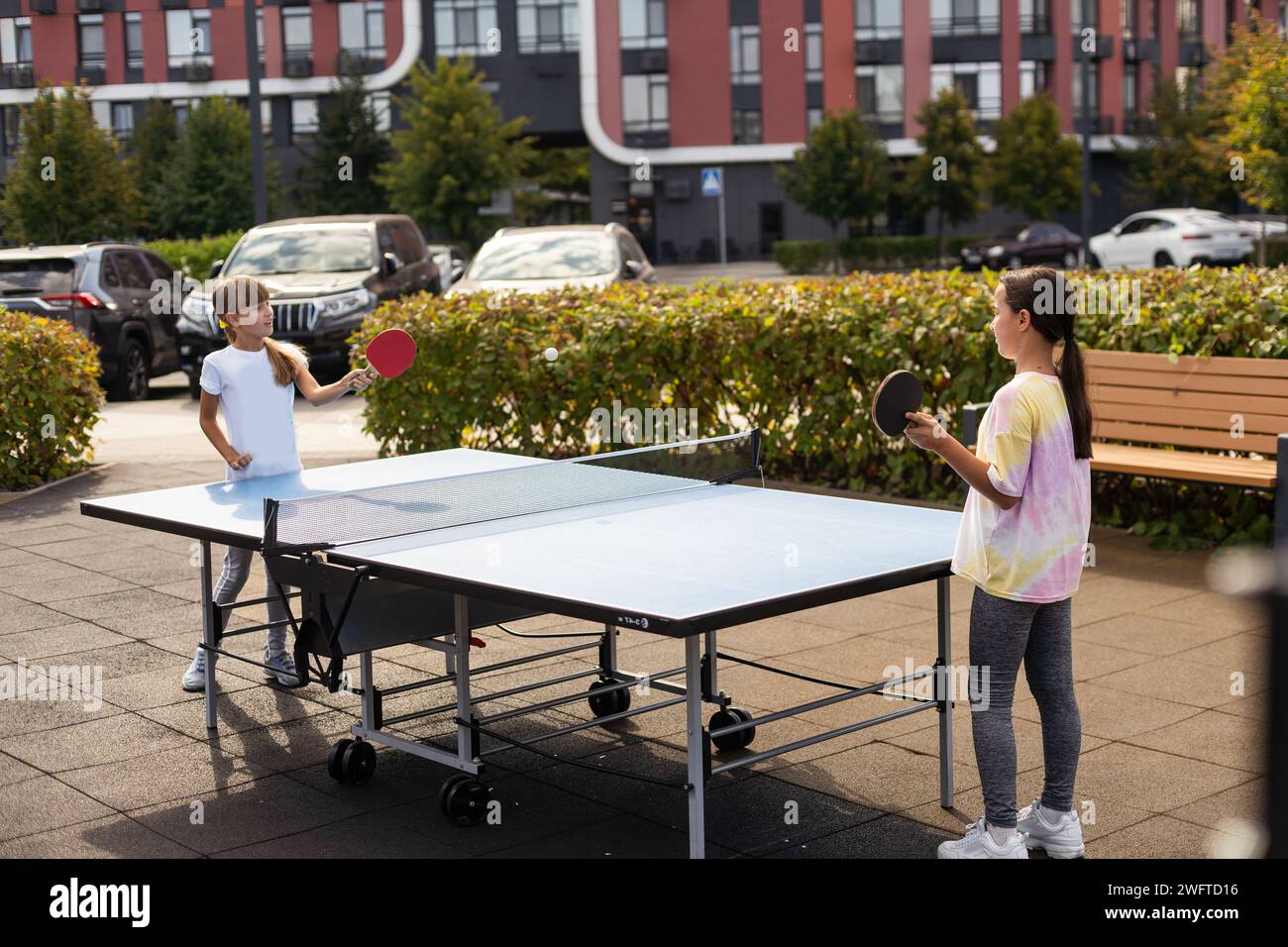 Little children playing ping pong in park Stock Photo - Alamy