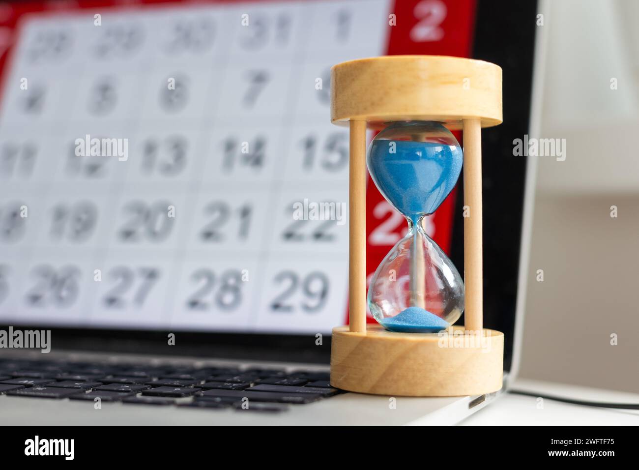 Time passing concept, time slipping away. Hourglass and the calendar ...