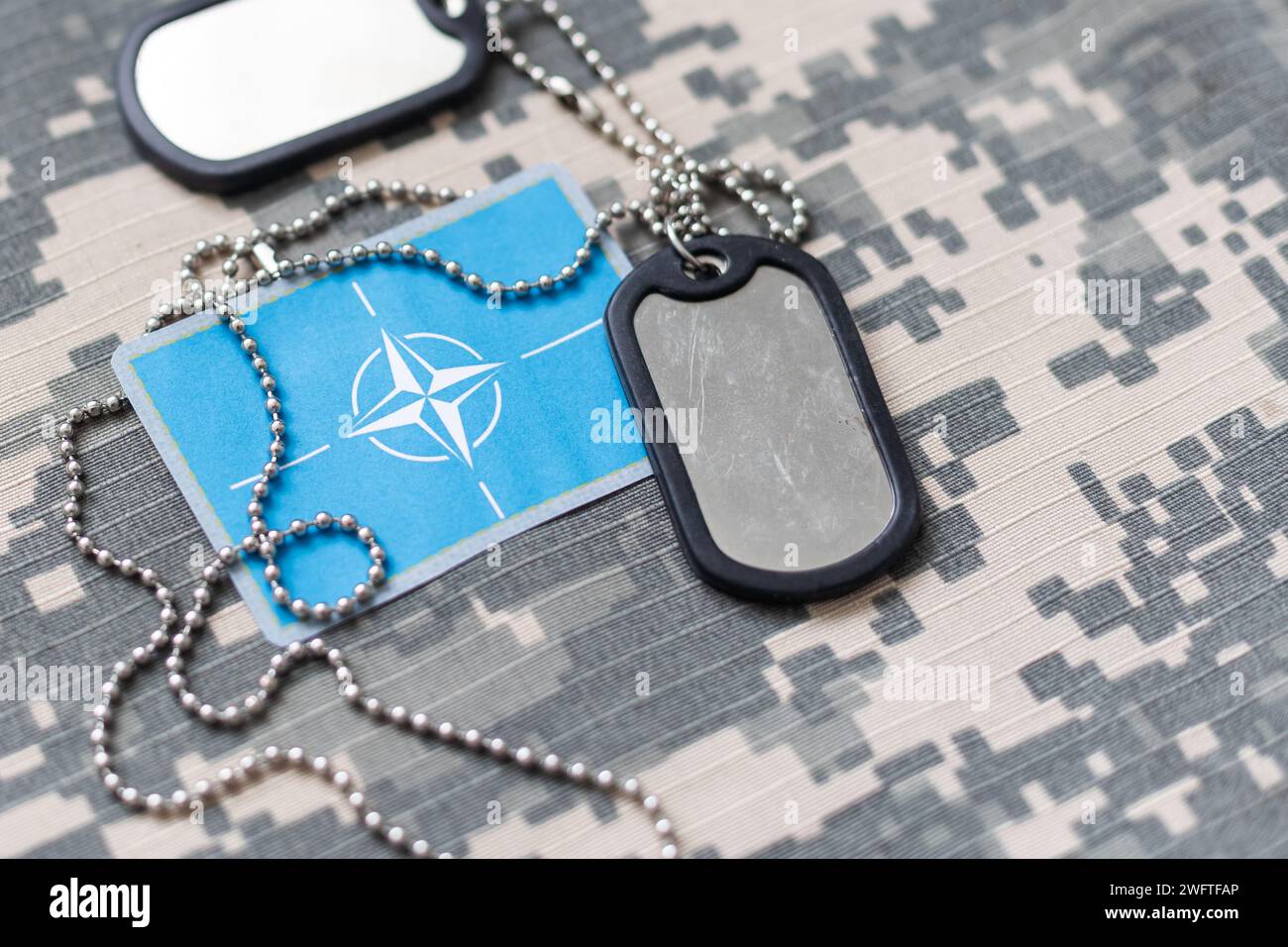 Army tokens on military uniform background Stock Photo - Alamy