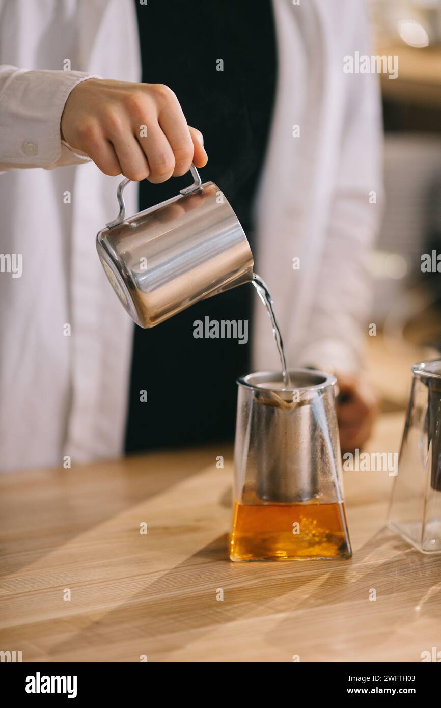 A young barista man prepares delicious teas in a modern cafe Stock ...