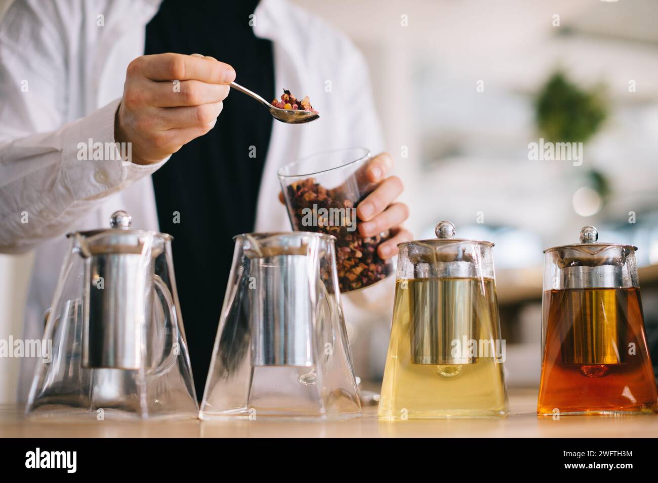 A young barista man prepares delicious teas in a modern cafe Stock ...