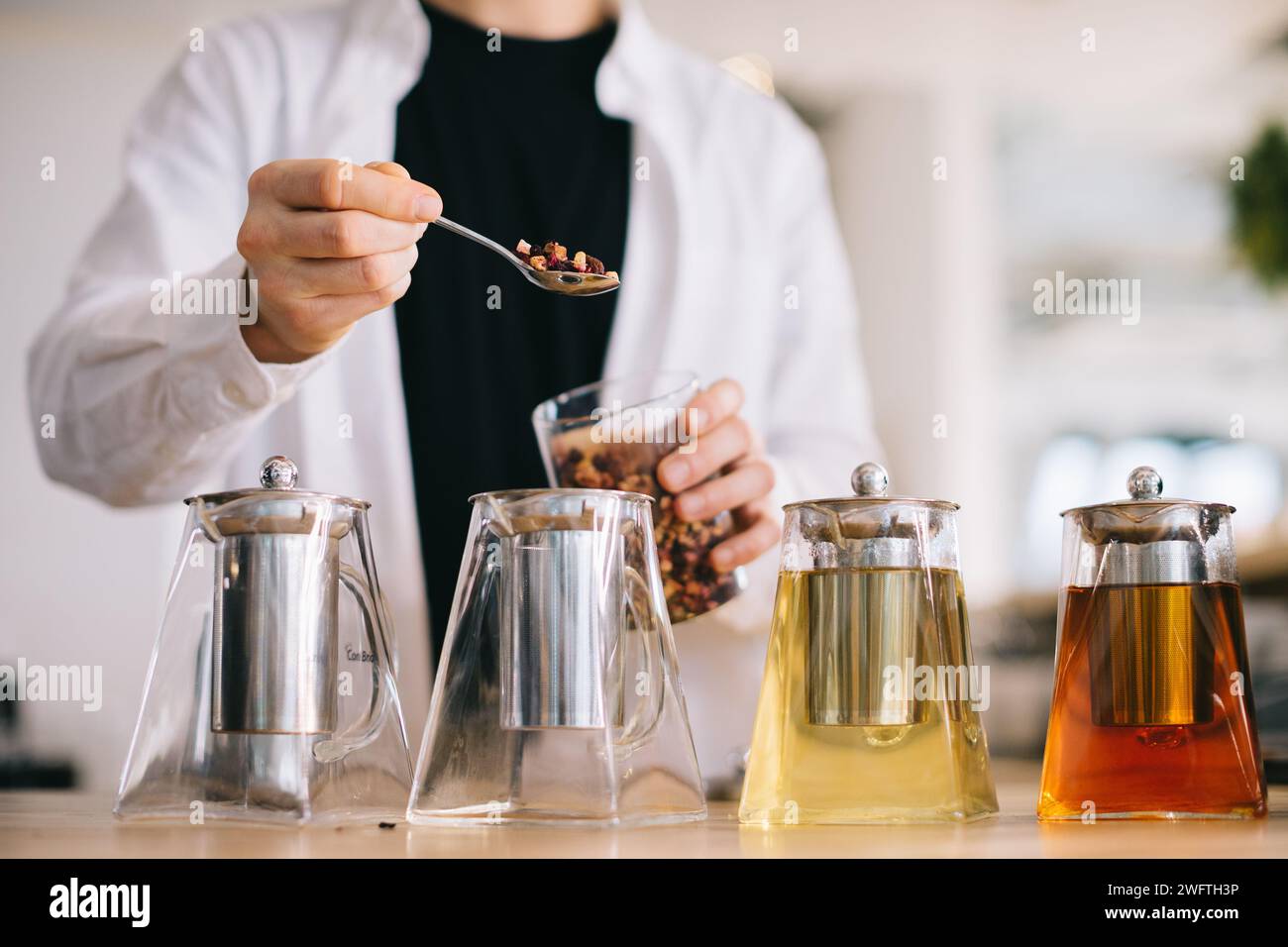 A young barista man prepares delicious teas in a modern cafe Stock ...