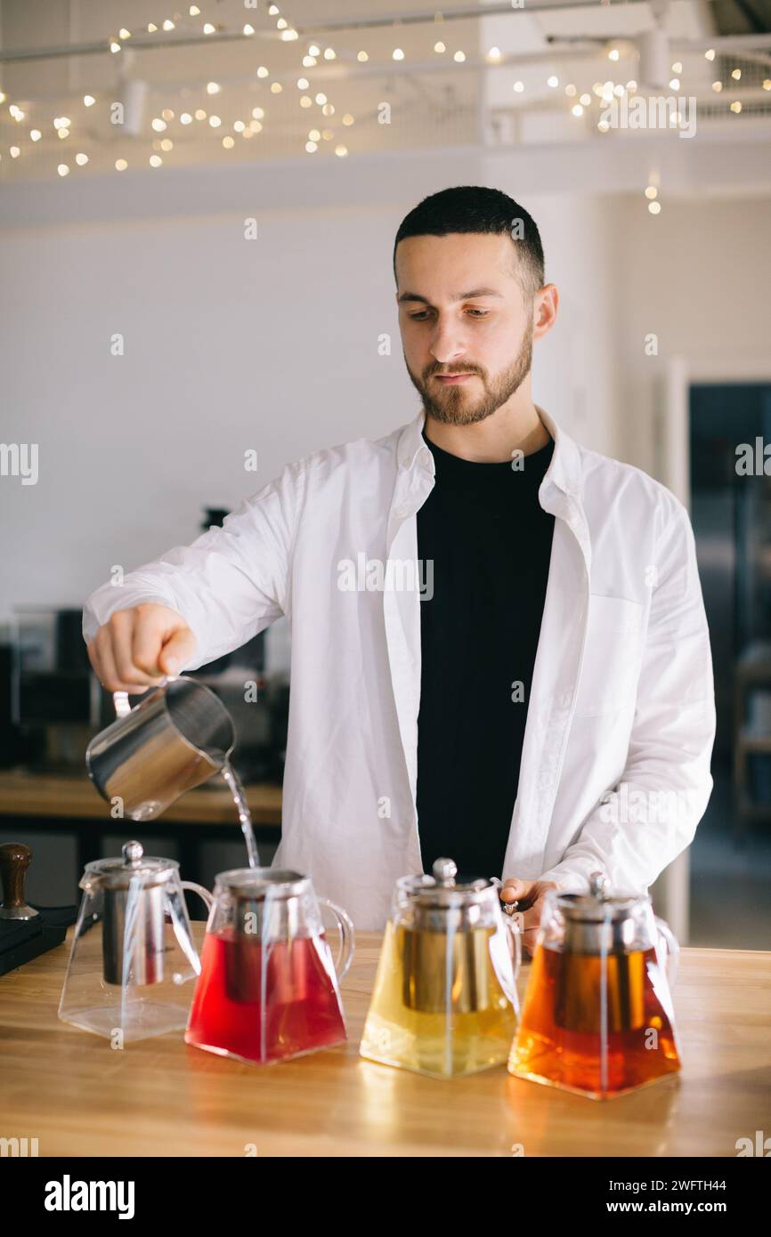 A young barista man prepares delicious teas in a modern cafe Stock ...