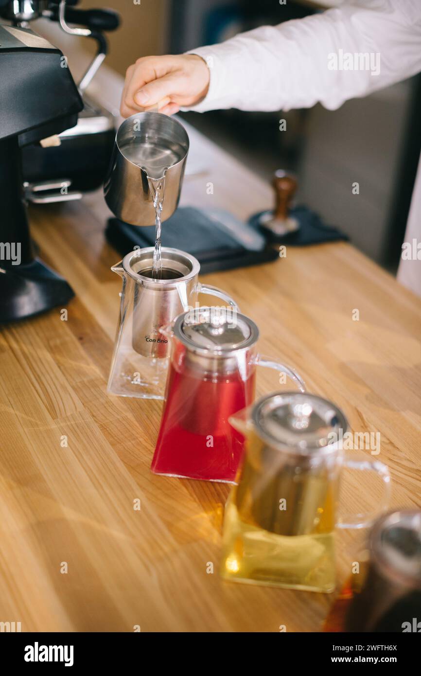 A young barista man prepares delicious teas in a modern cafe Stock ...