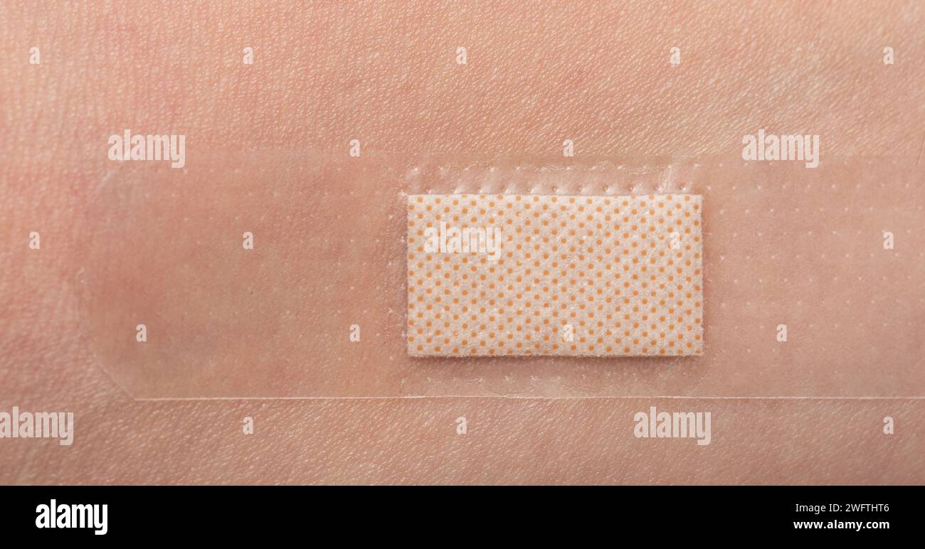 Transparent band aid on human skin macro close up view Stock Photo - Alamy
