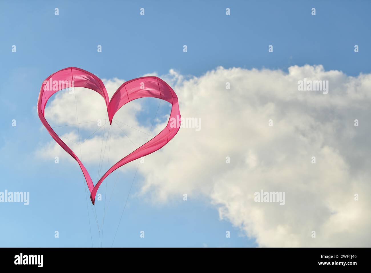 Pink heart kite is flying in the wind Stock Photo - Alamy