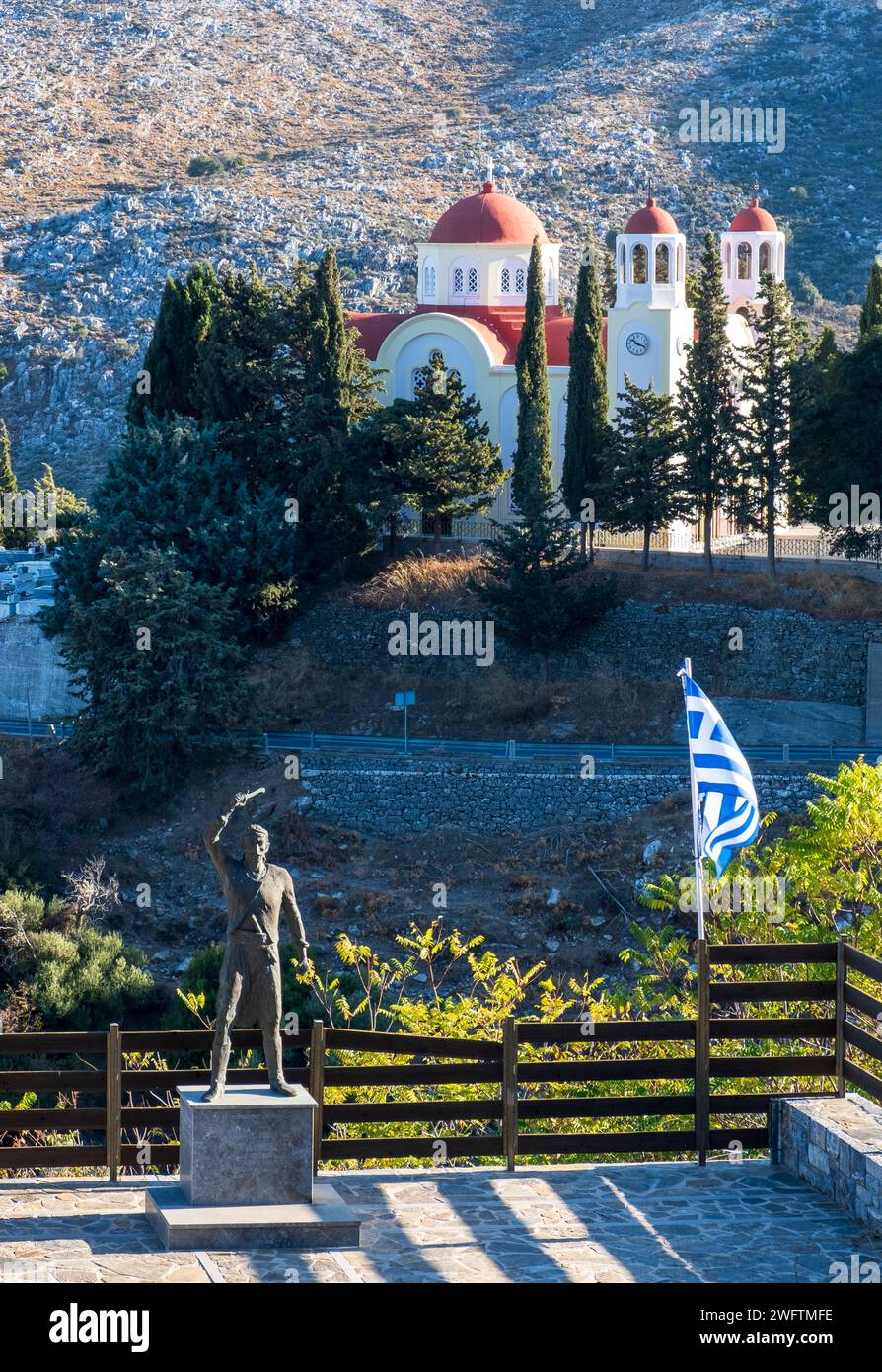 Statue of Cretan resistance fighter near church in mountain village of ...