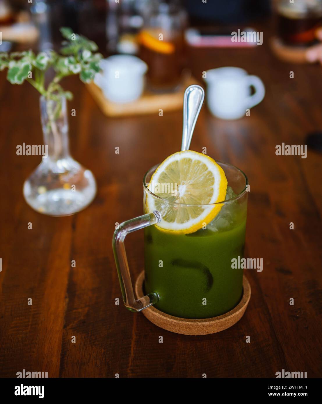 Green tea matcha iced tea and pitcher and a lemon poolside. Iced matcha ...