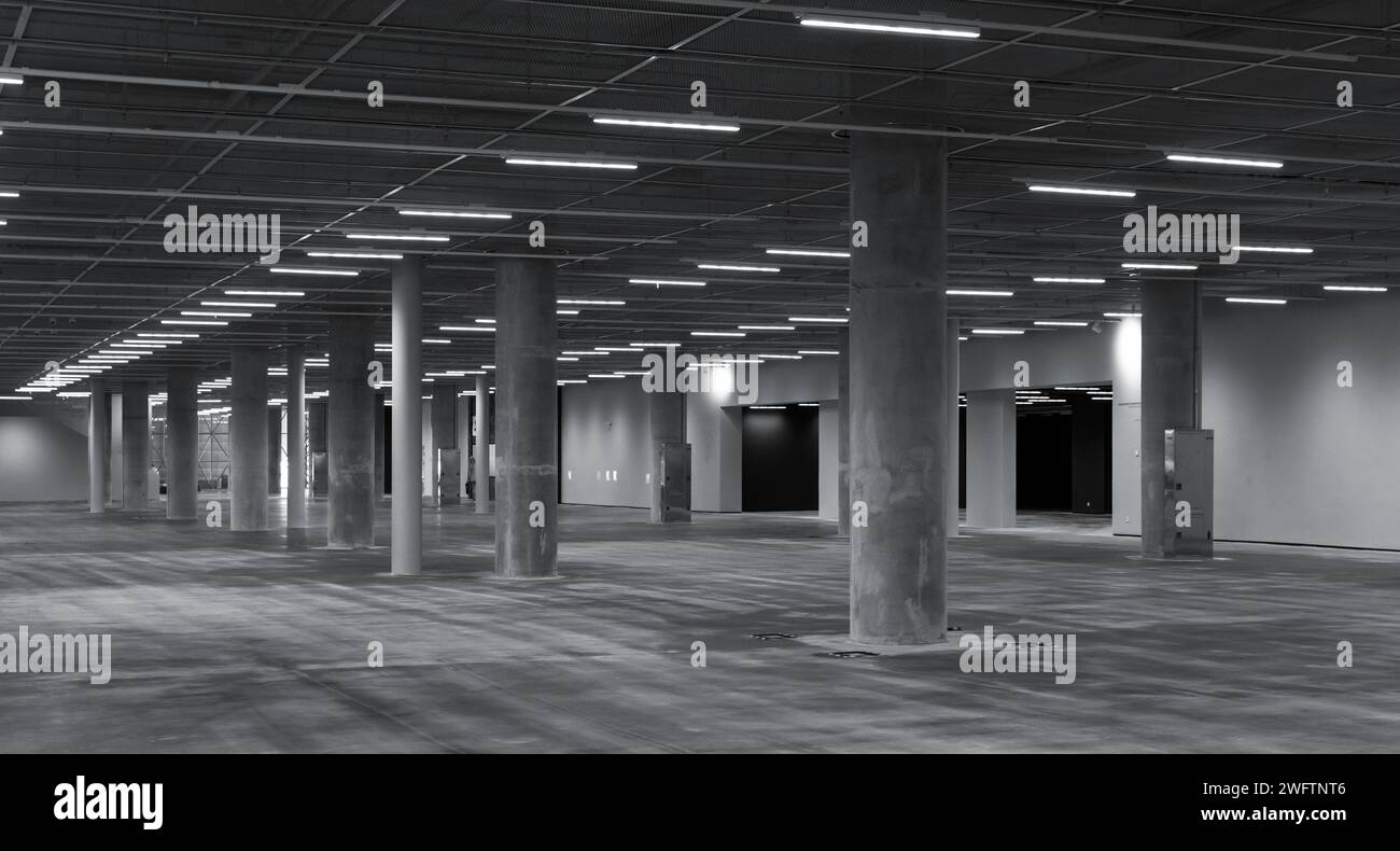 Abstract empty industrial interior with concrete pillars and neon ...