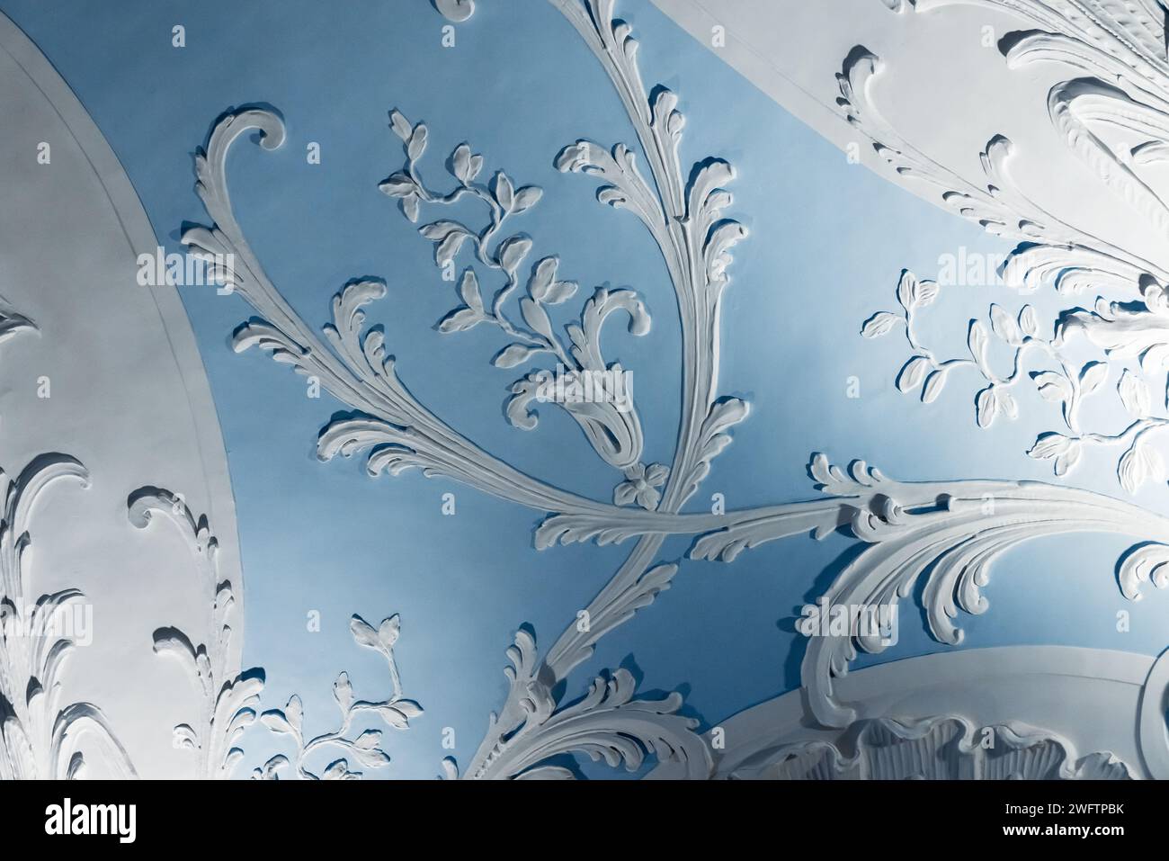 White bas-relief over blue ceiling background, wall design gypsum ...