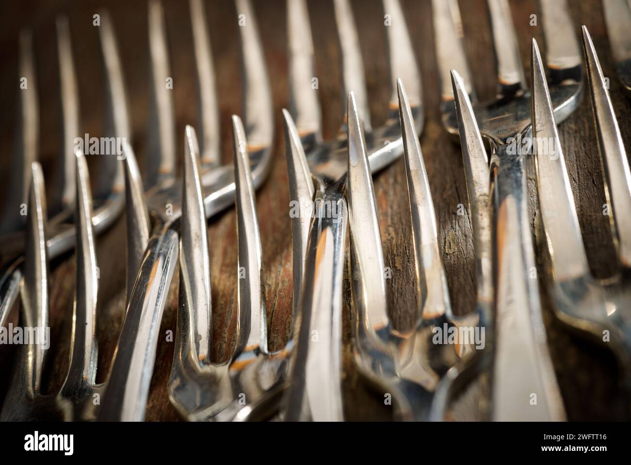 Close up of small old silver forks on a wood table Stock Photo - Alamy